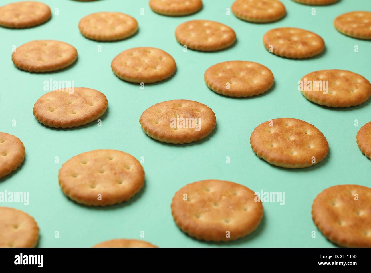 Flat lay with cracker biscuits on mint background Stock Photo - Alamy