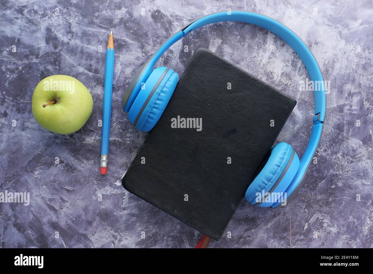 Audio book concept. Headphones and notepad on black background Stock ...