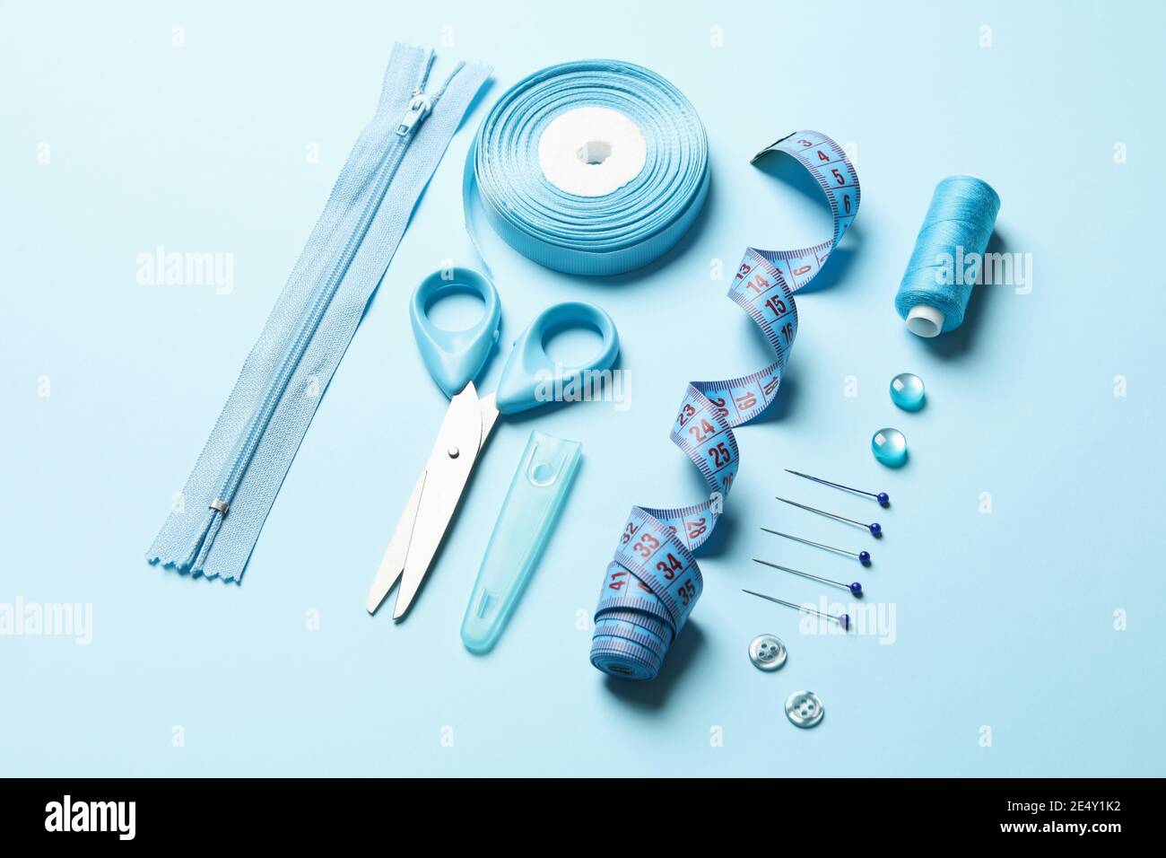 Woman sewing blue cloth hi-res stock photography and images - Alamy