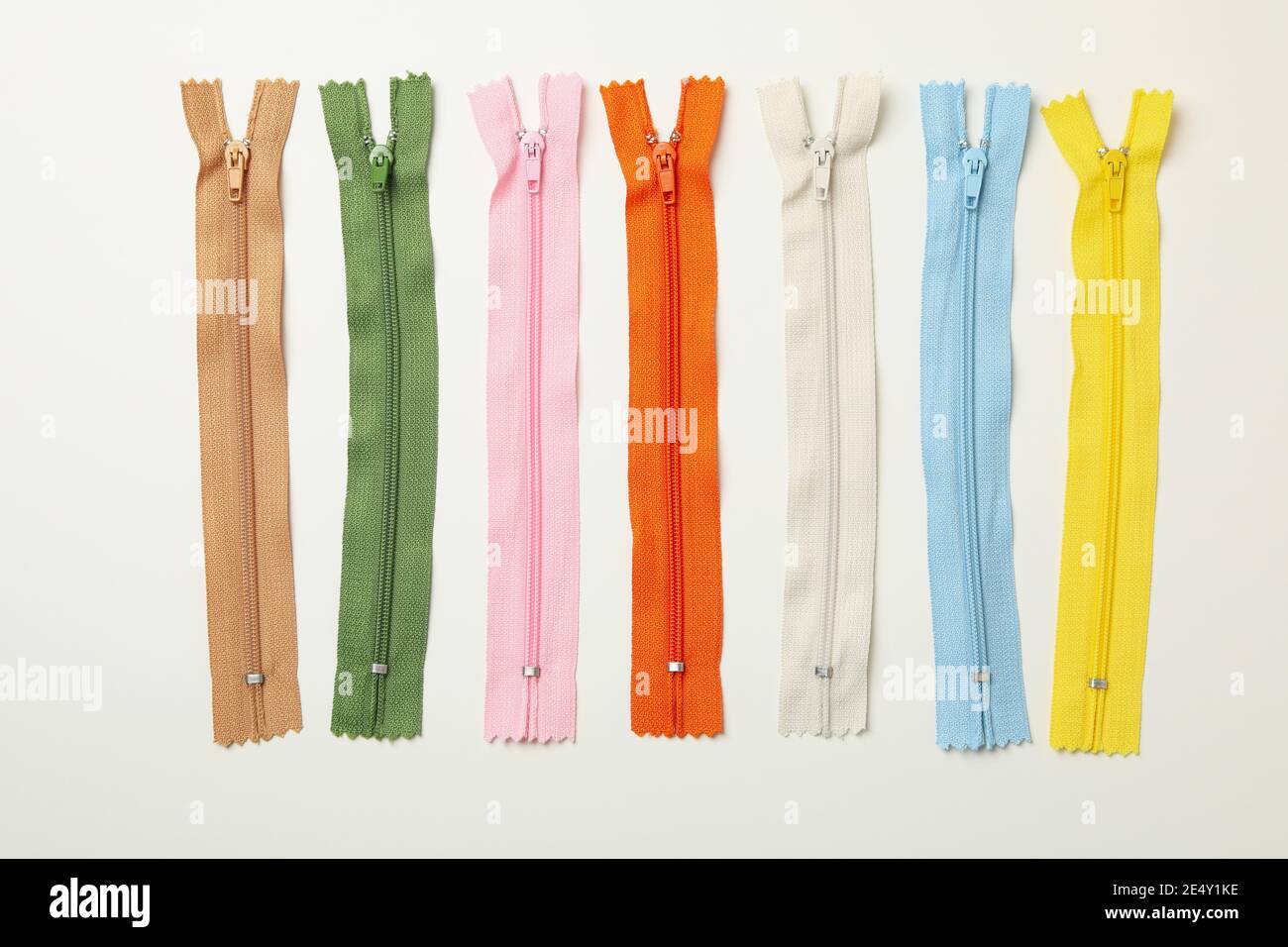 Color zippers on white background, top view Stock Photo - Alamy