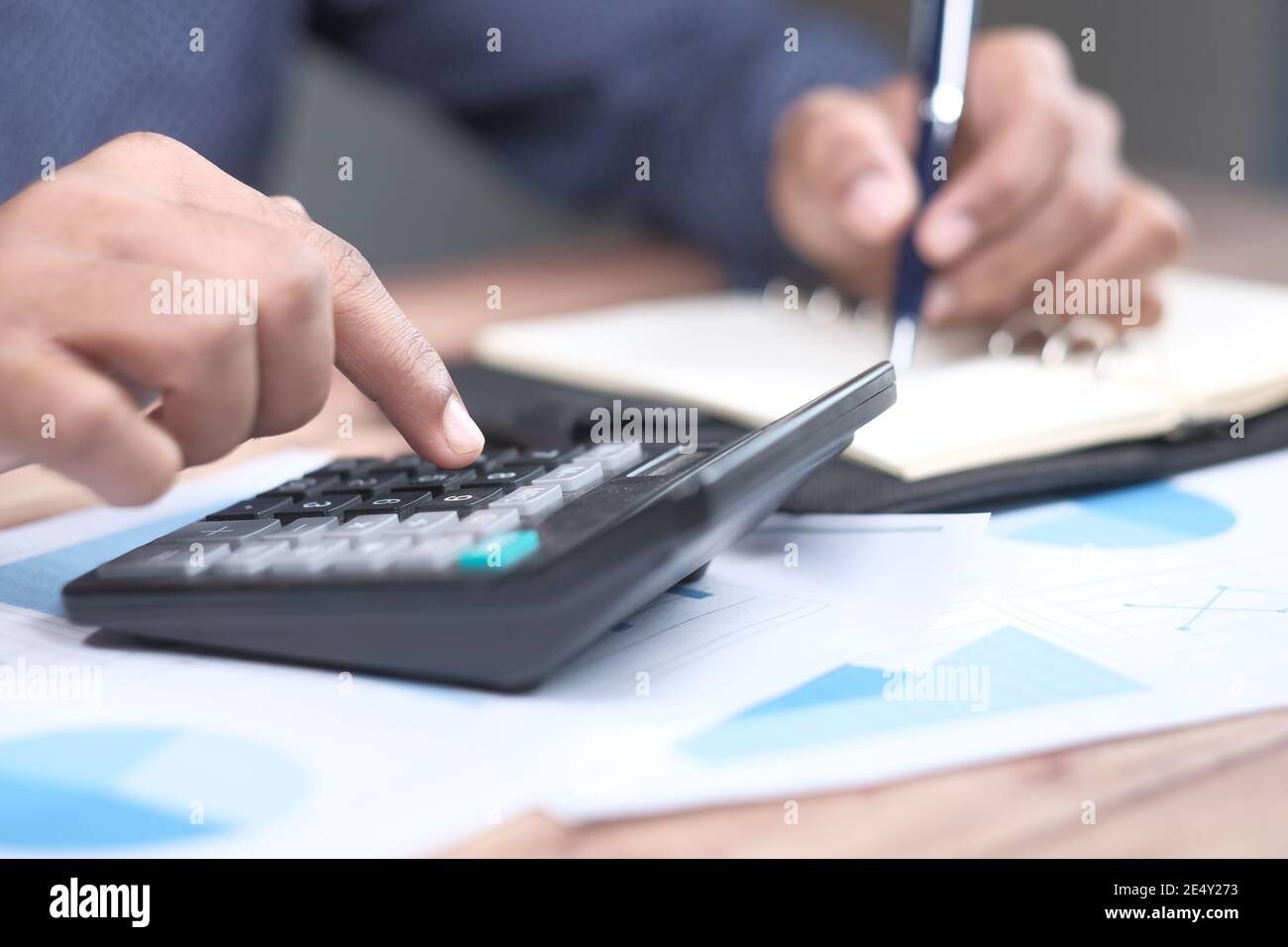 close up of accountant using calculator on office desk Stock Photo - Alamy