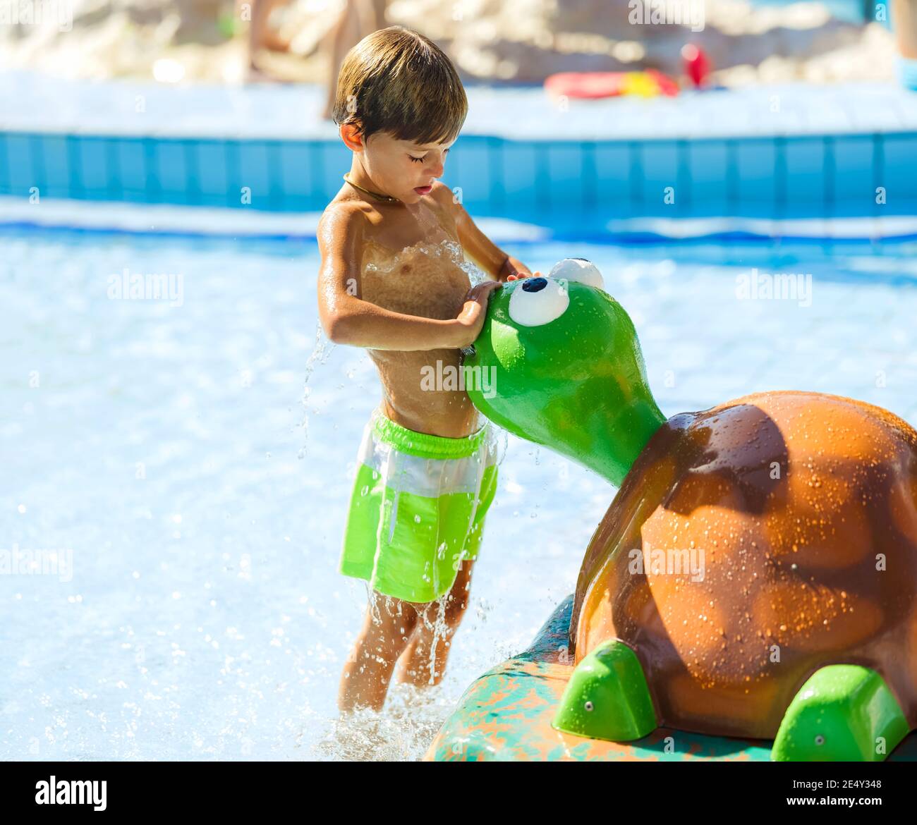 Child playing on water slide hi-res stock photography and images - Alamy