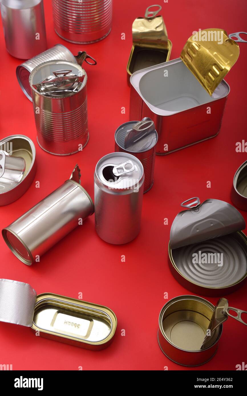 Elevated view of a set of cans on red background Stock Photo - Alamy