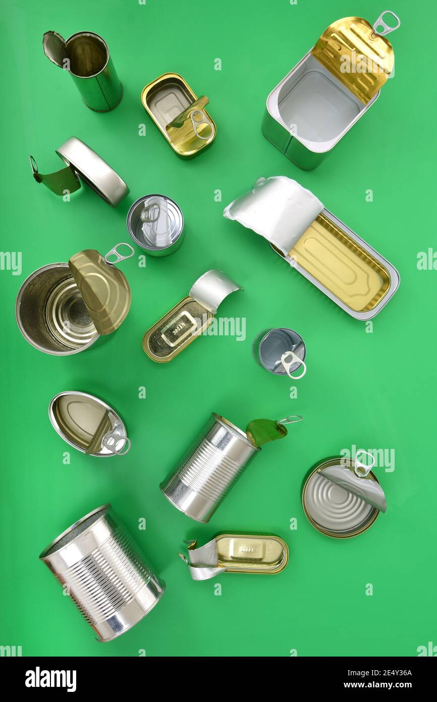 top view of a set of cans on green background Stock Photo - Alamy