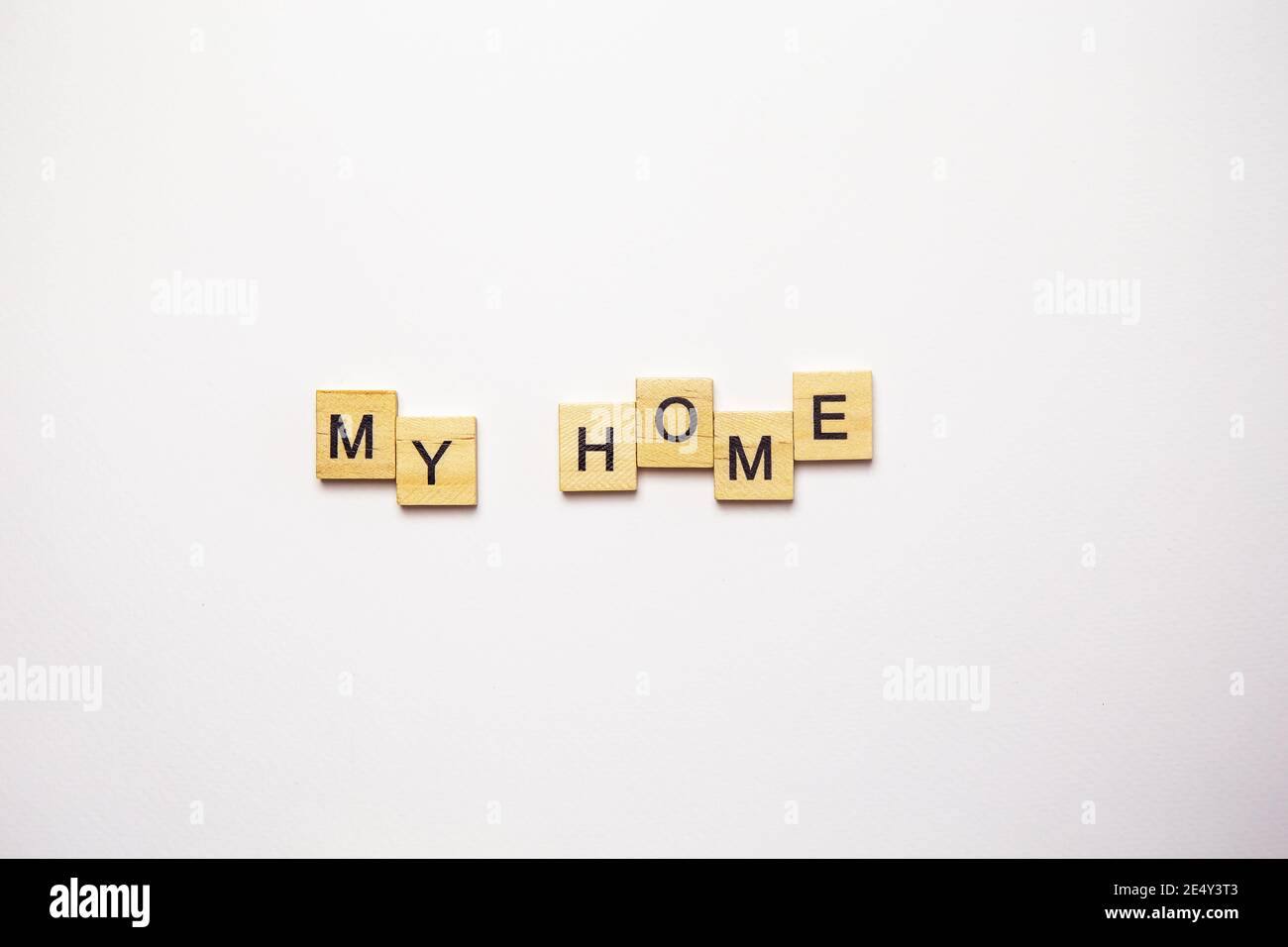 Text my home lined with wooden cubes on white background Stock Photo ...