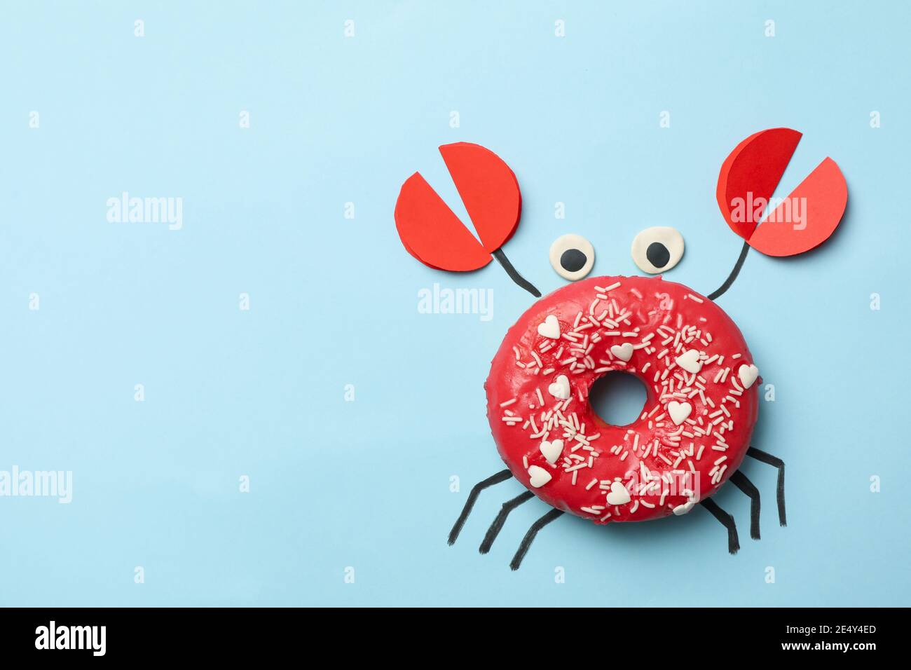 Crab made of donut on blue background Stock Photo - Alamy