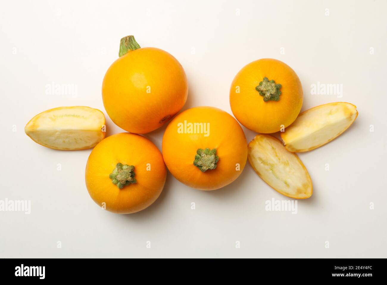 Round zucchini and slices on white background, top view Stock Photo - Alamy