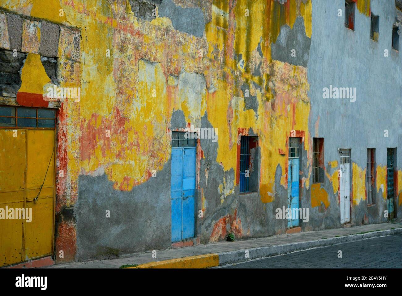 Old abandoned factory building colorful faded facade in Atlixco, Puebla ...
