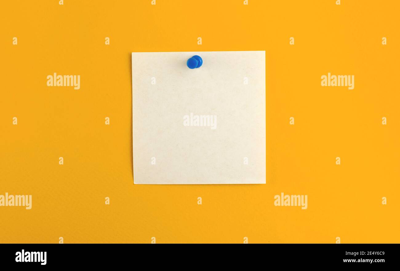 Pinned notepad sheet of square paper on isolated yellow background, for ...
