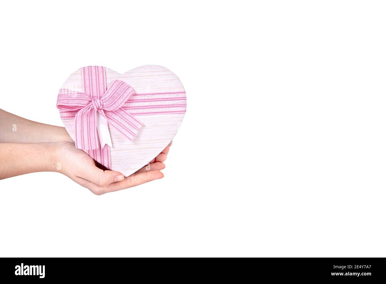 A large gift in the shape heart in a hand on a white background and ...