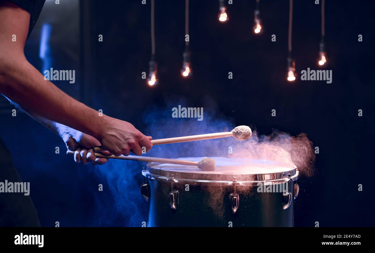 The percussionist plays with sticks on the floor tom on under studio ...