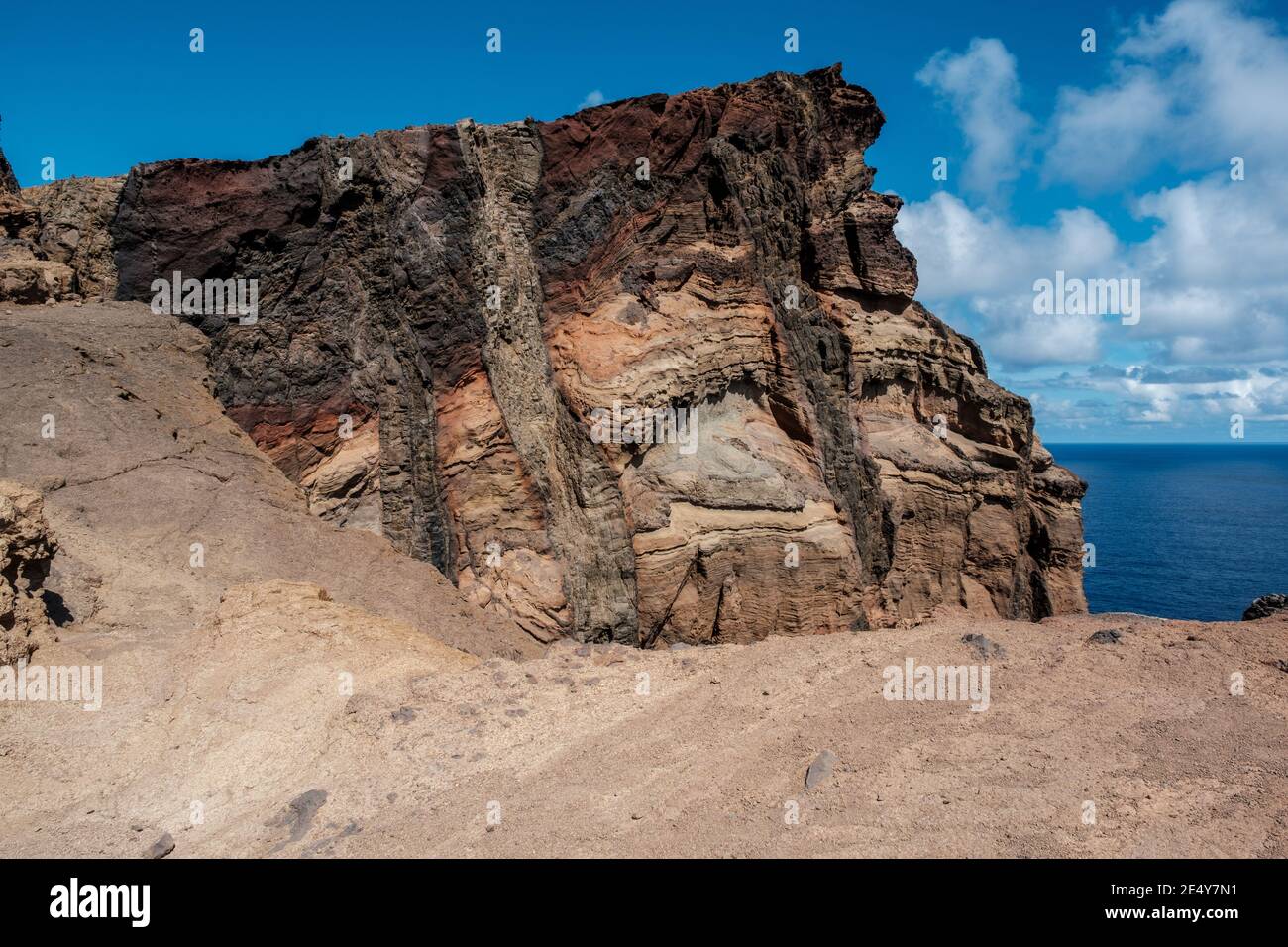 Tropical Island arid mountains full of dirt and rock in a summer day ...
