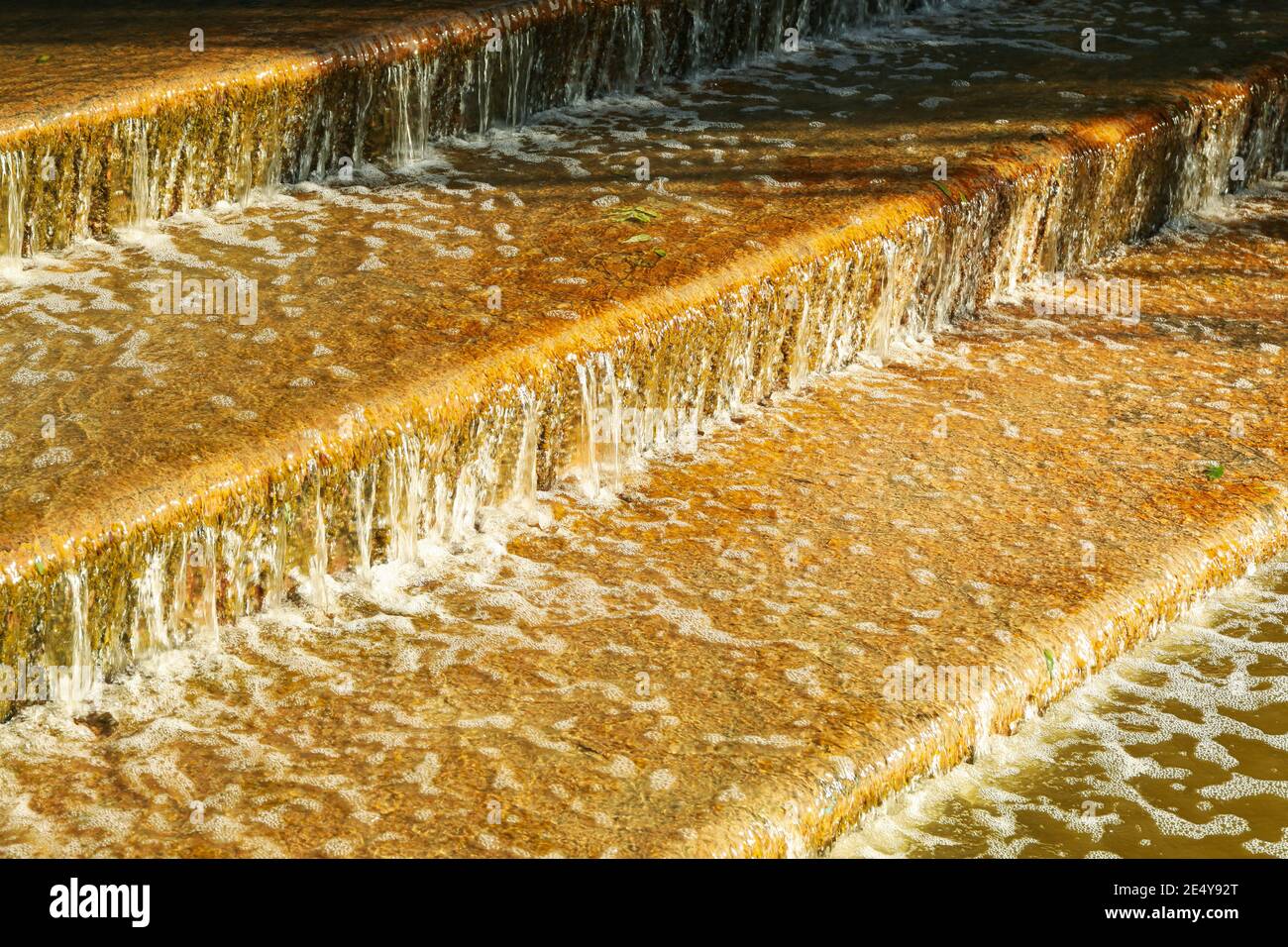 Artificial stair-stepping waterfall in sunny morning Stock Photo - Alamy