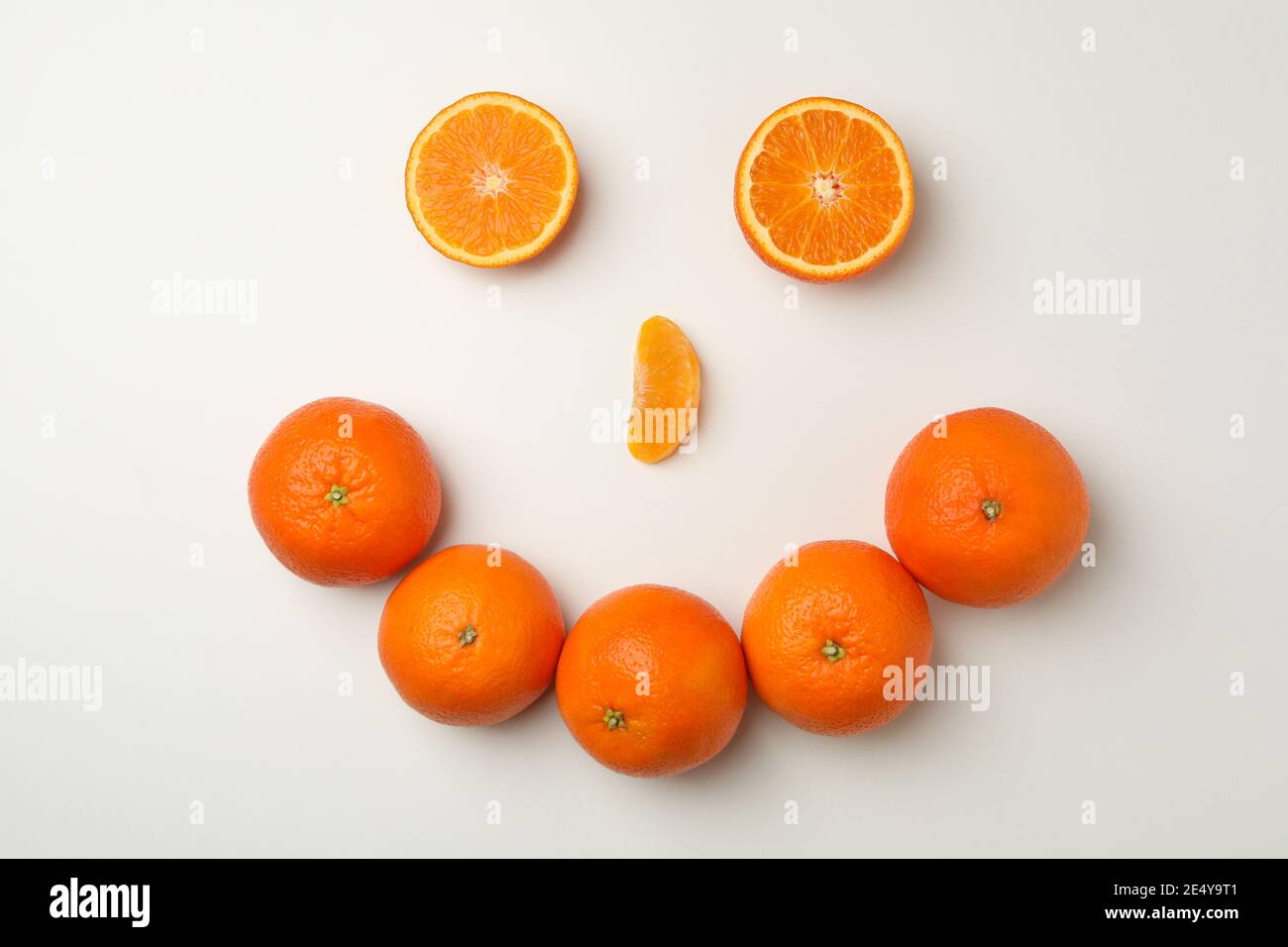 Happy face made of mandarins on white background Stock Photo - Alamy