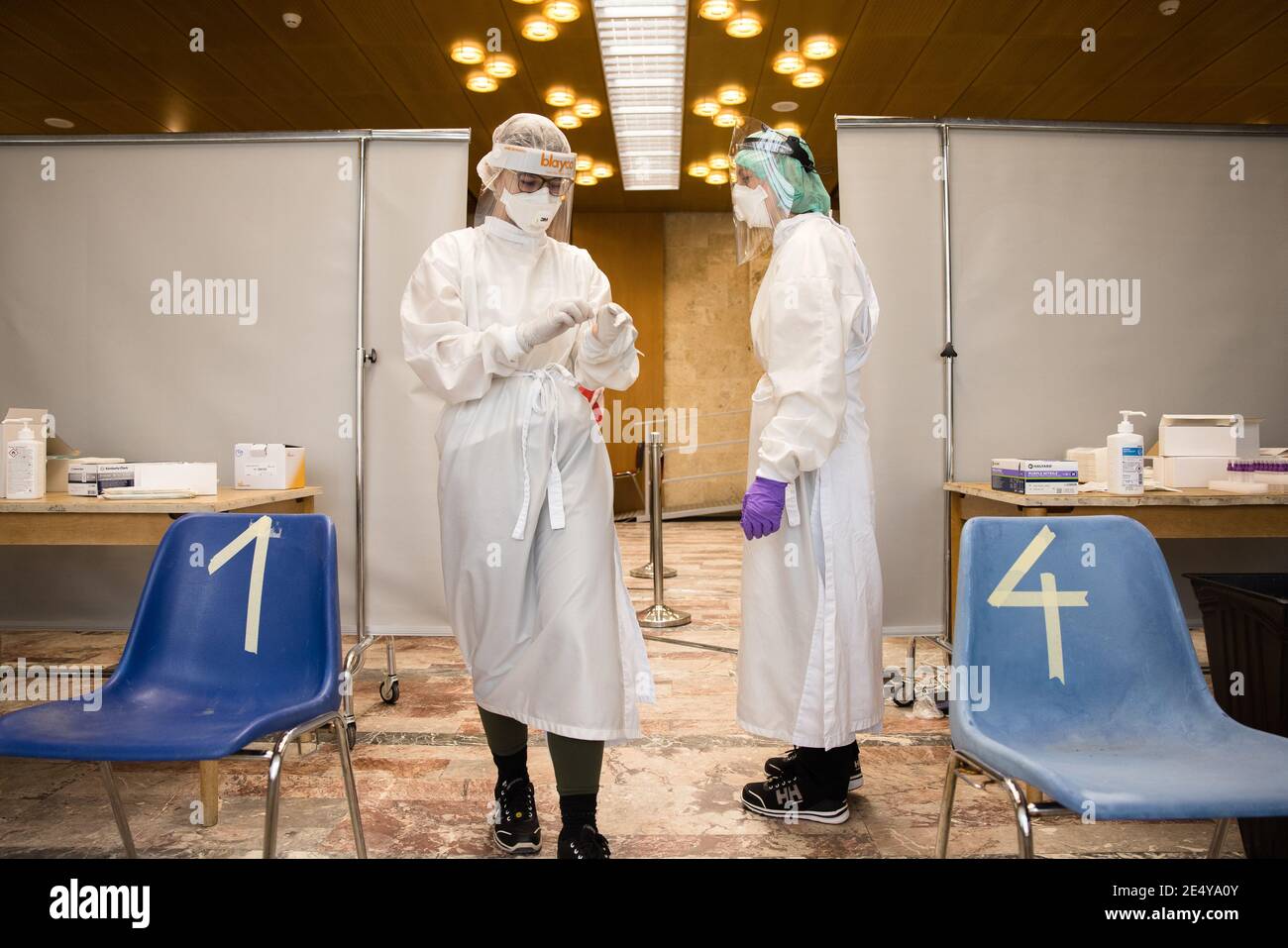 Medical personnel wait for elementary school teachers to arrive for ...