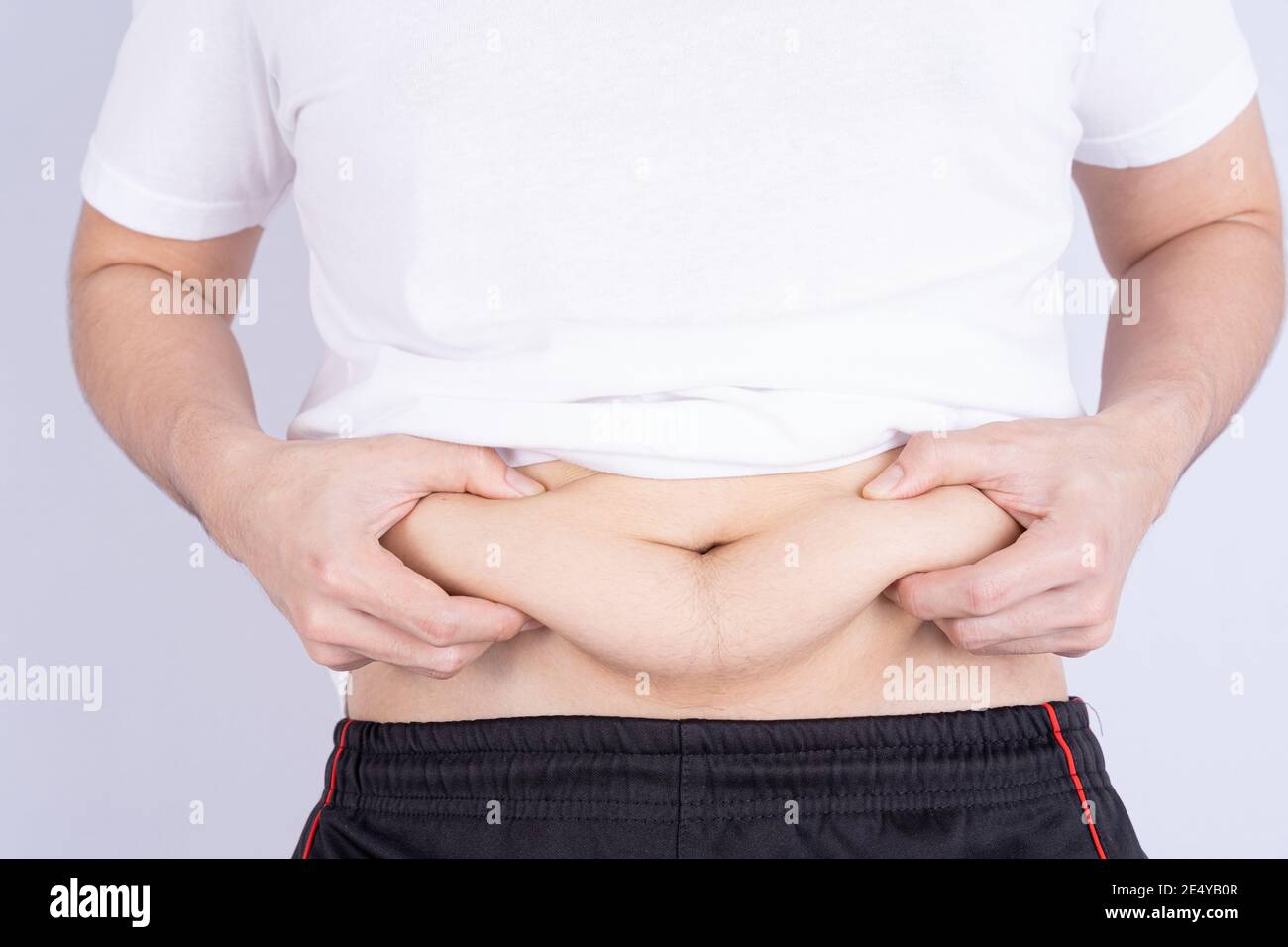 Fat man holding excessive fat belly, overweight fatty belly isolated ...