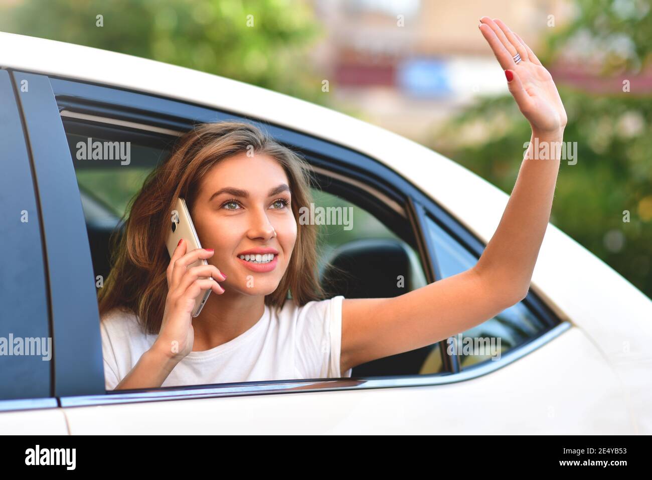 Woman waving and laughing hi-res stock photography and images - Alamy