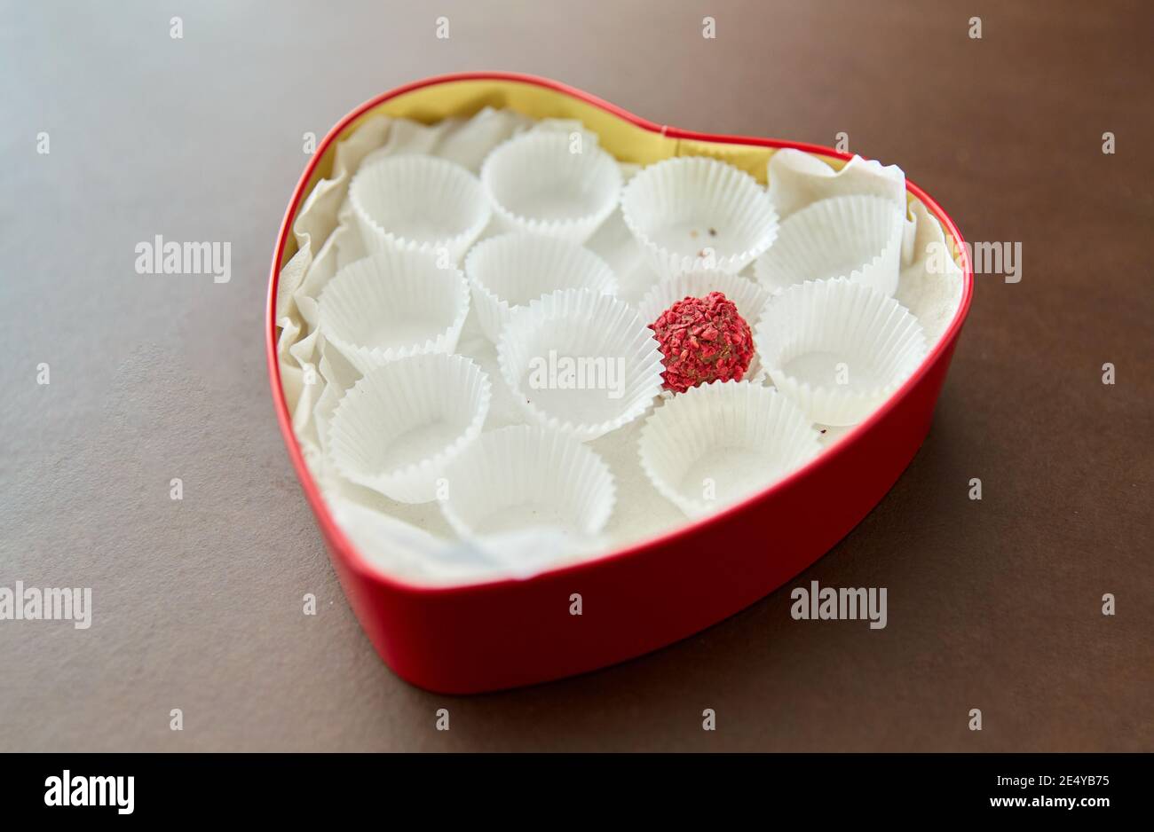 one candy in red heart shaped chocolate box Stock Photo - Alamy
