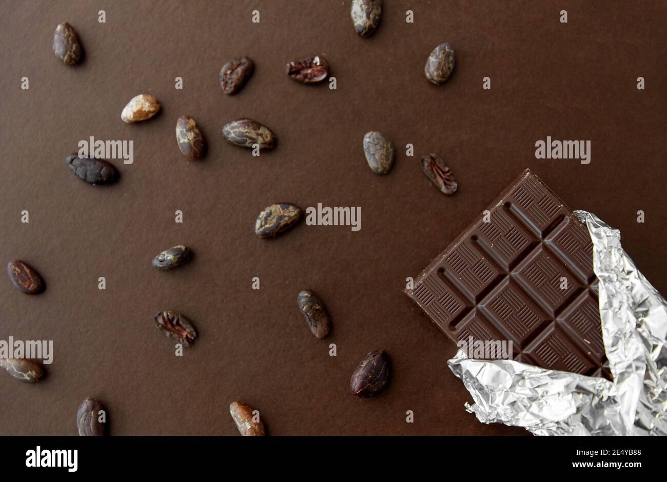 dark chocolate bar in foil wrapper and cocoa beans Stock Photo - Alamy