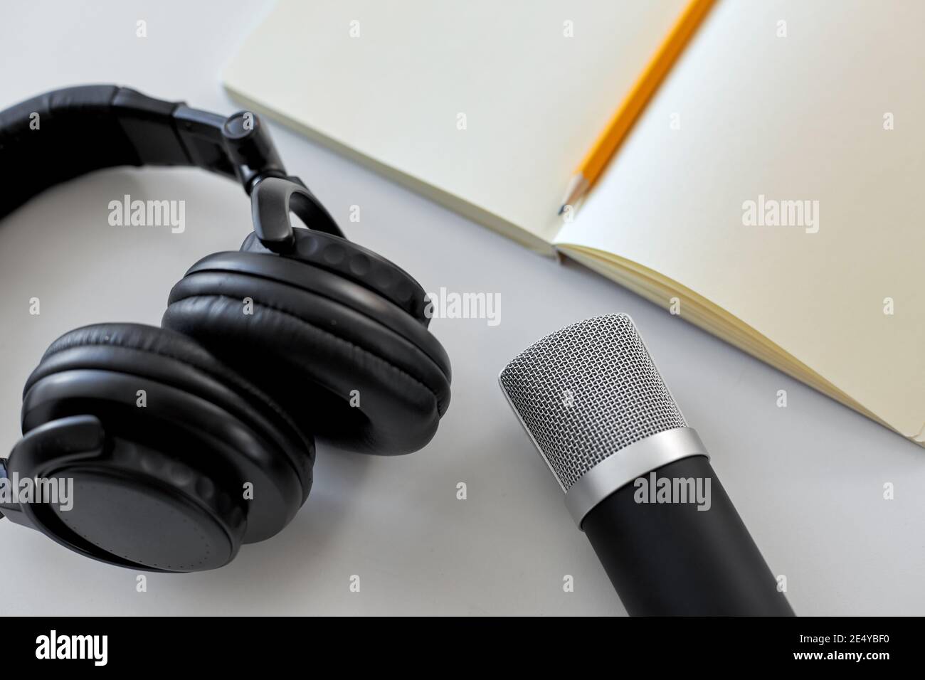 headphones, microphone and notebook with pencil Stock Photo - Alamy