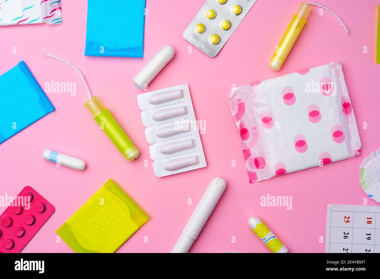 Сontraceptive pills, hygienic pads and tampons on pink background Stock ...