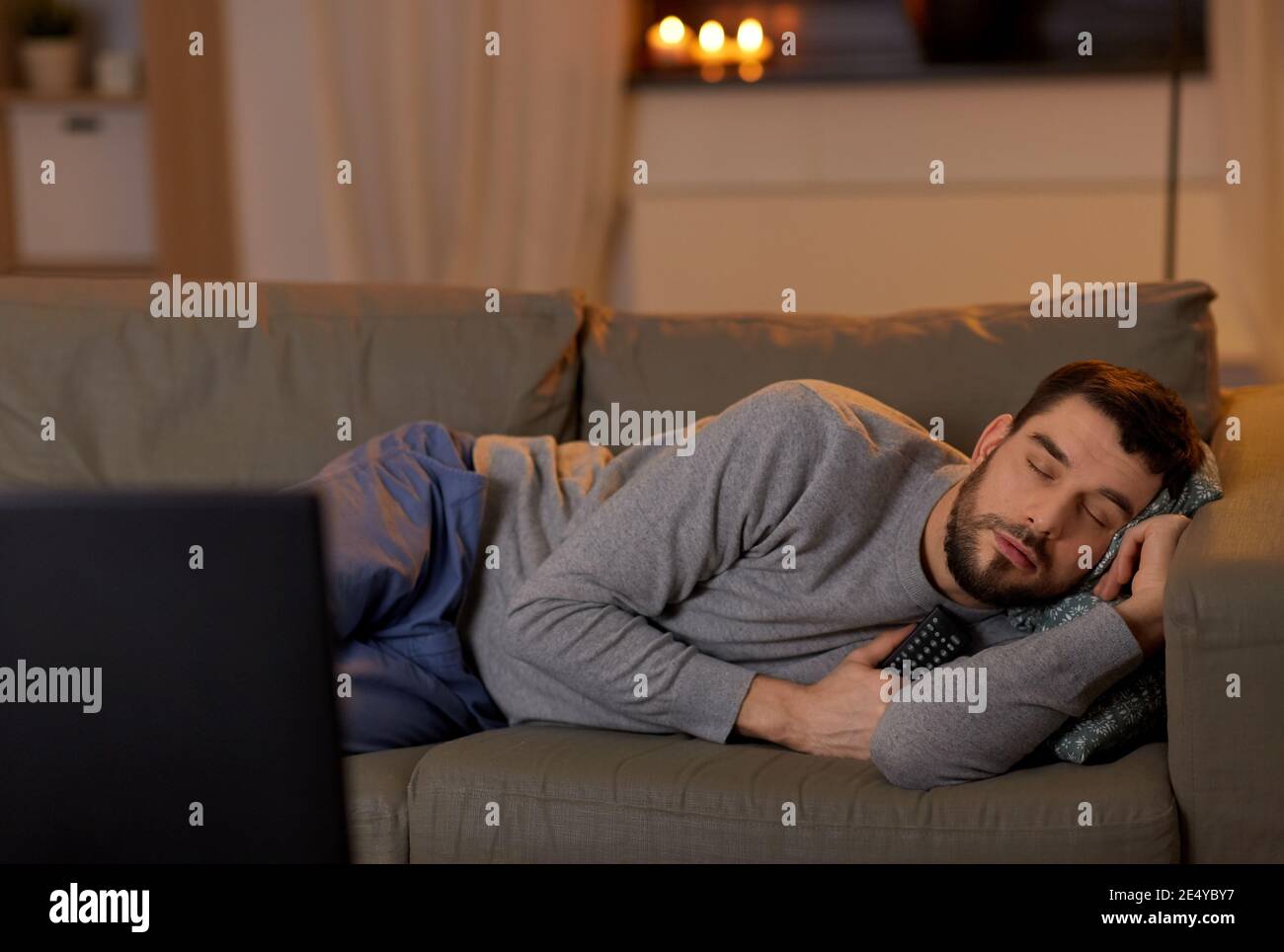 man sleeping on sofa with tv remote at home Stock Photo - Alamy