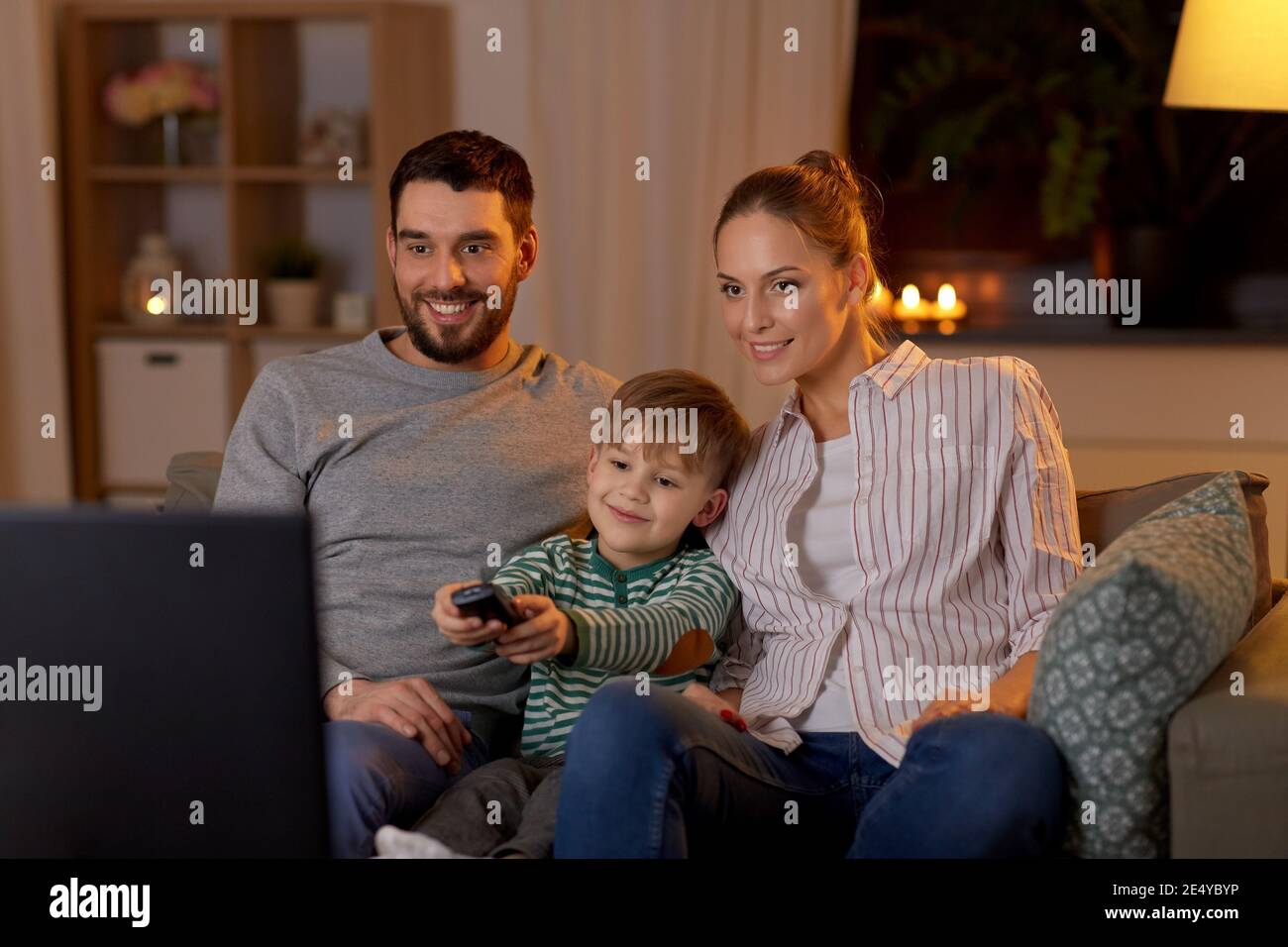 happy family watching tv at home at night Stock Photo - Alamy