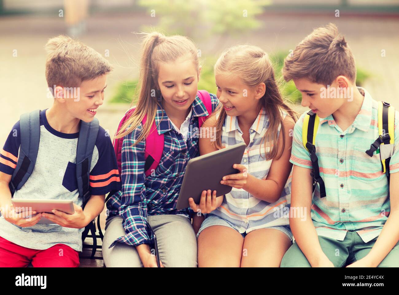 group of happy elementary school students talking Stock Photo - Alamy