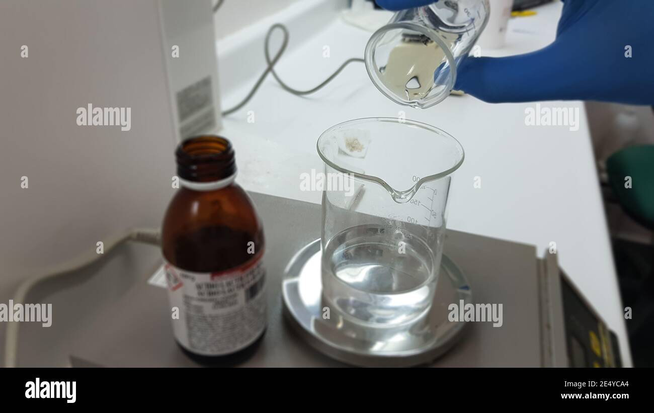 Process of medicine investigation done through a beaker in the ...