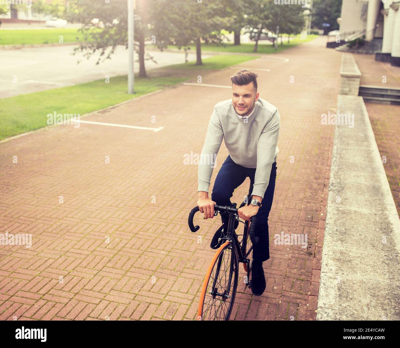 Happy businessman riding bicycle hi-res stock photography and images ...