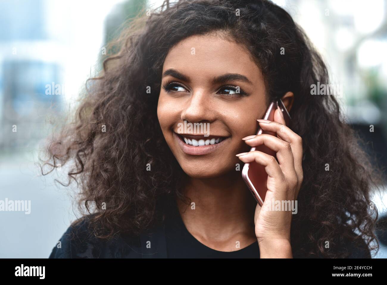 Happy beautiful woman walking and writing or reading sms messages Stock ...