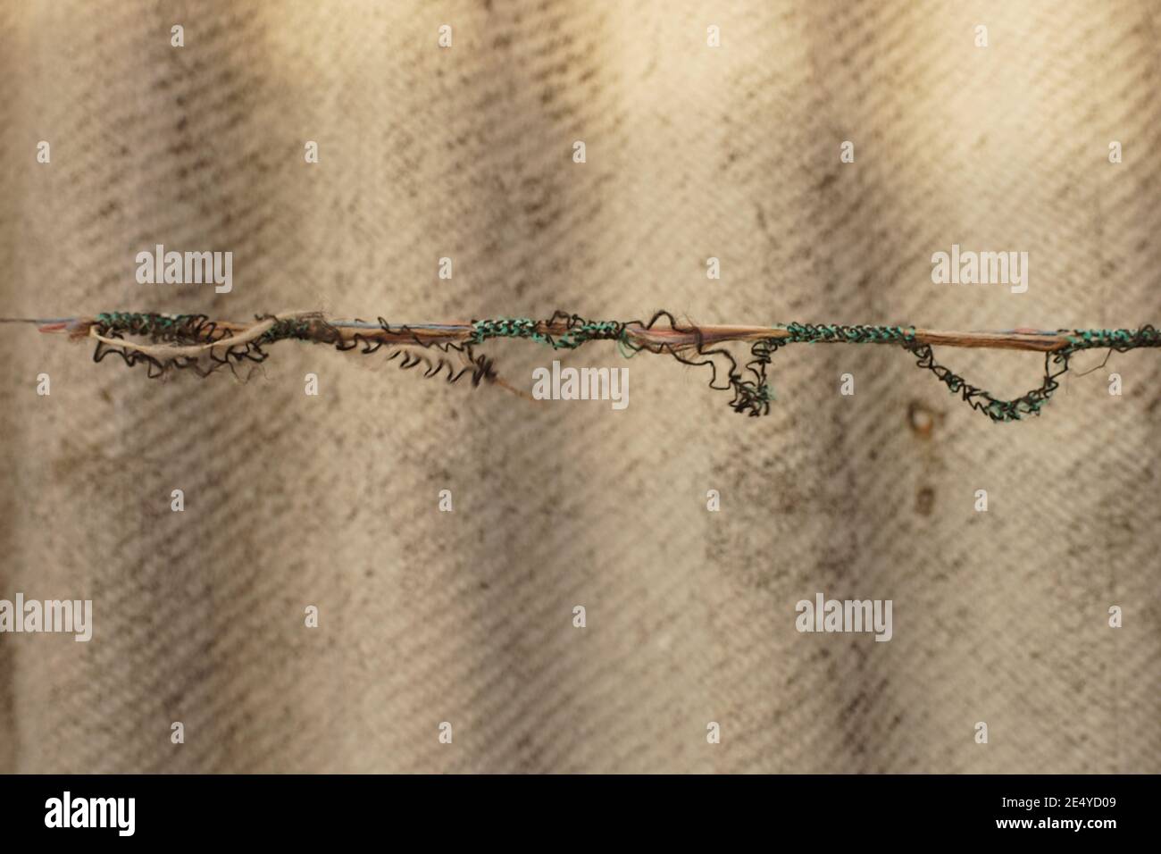 damaged torn rope close-up near slate fence Stock Photo - Alamy