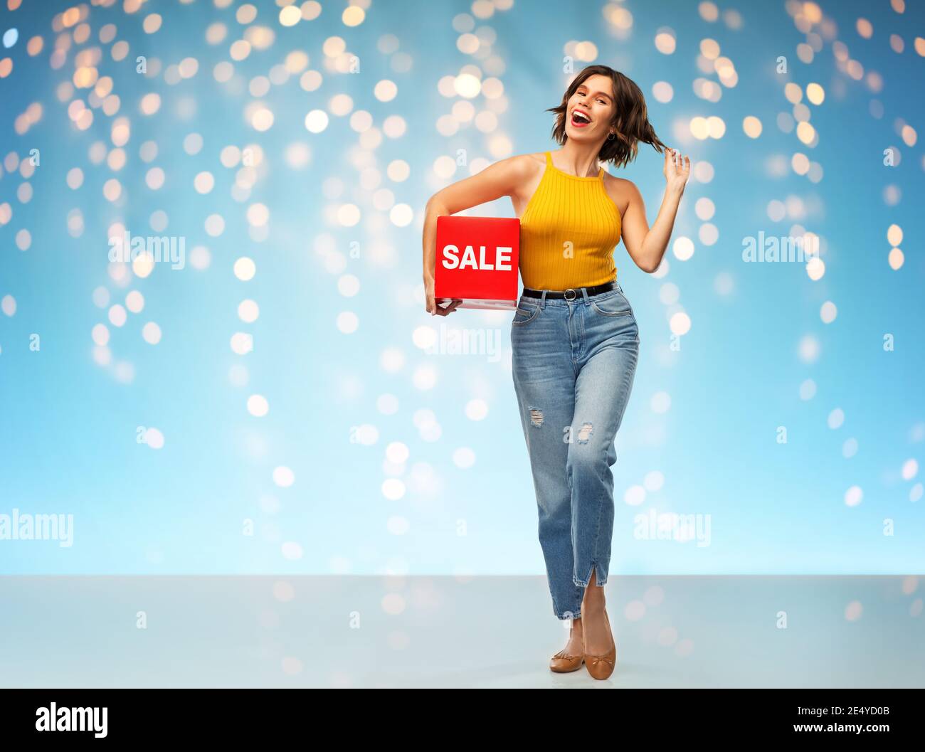happy smiling young woman posing with sale sign Stock Photo - Alamy
