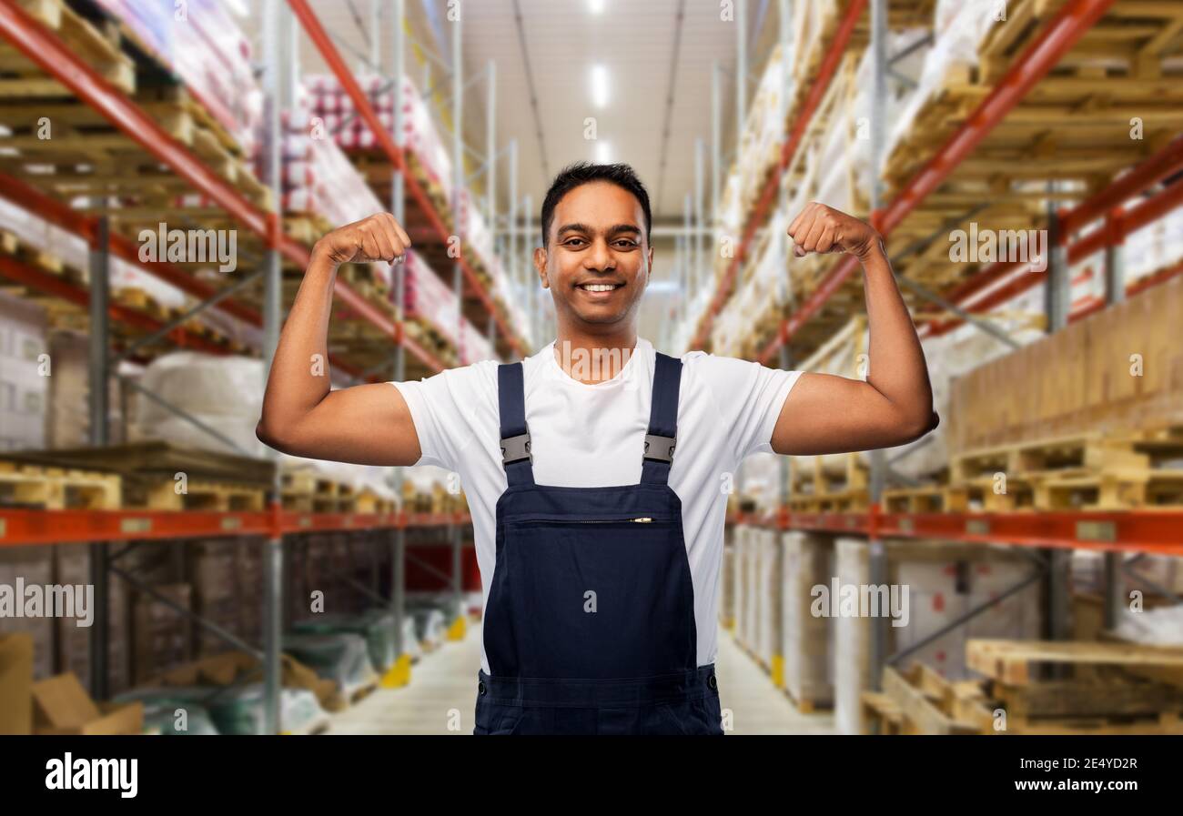 happy indian worker showing his power at warehouse Stock Photo - Alamy