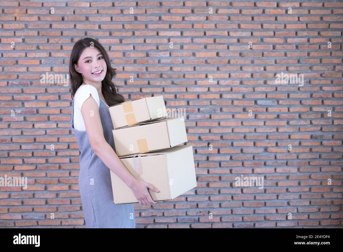 Asian woman packing boxes of parcels in her shopping online business at ...