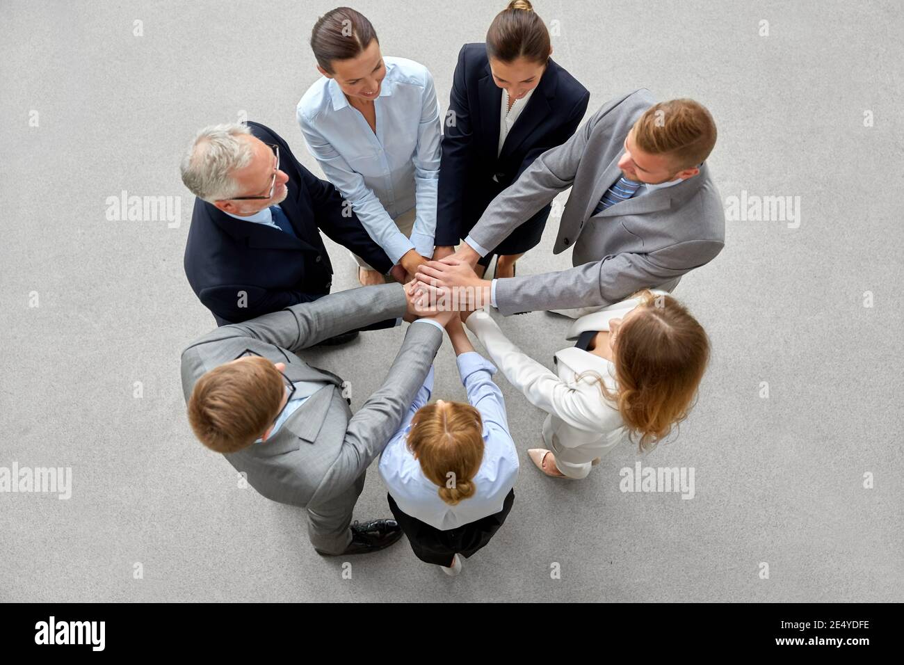 happy business people stacking hands Stock Photo - Alamy