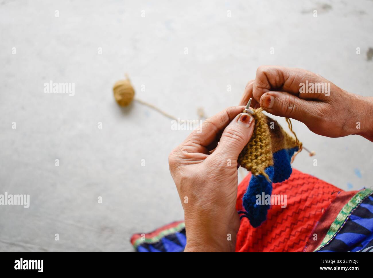 Indian Woman knitting woolen scarf Stock Photo - Alamy