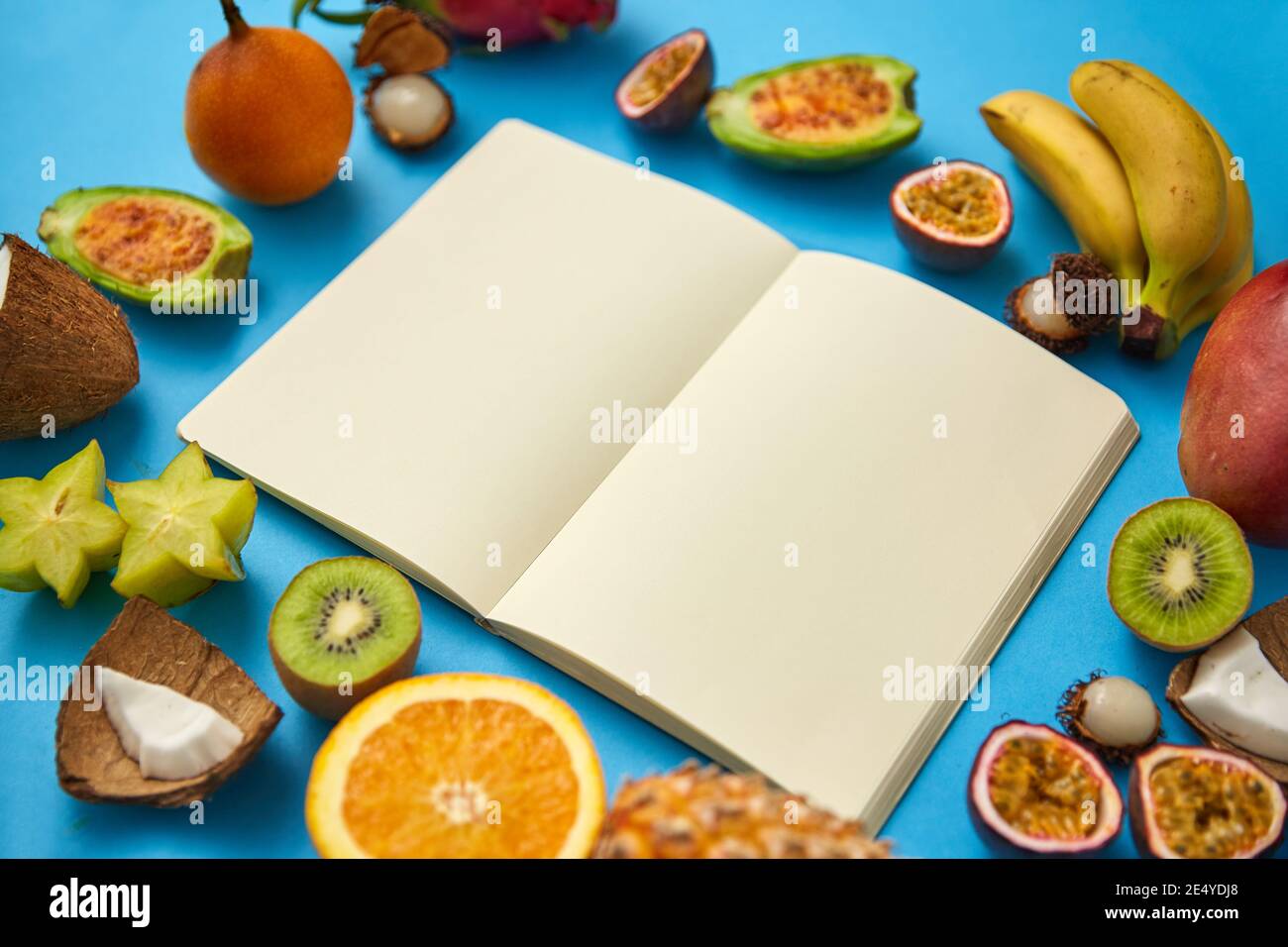 exotic fruits around notebook with empty pages Stock Photo - Alamy