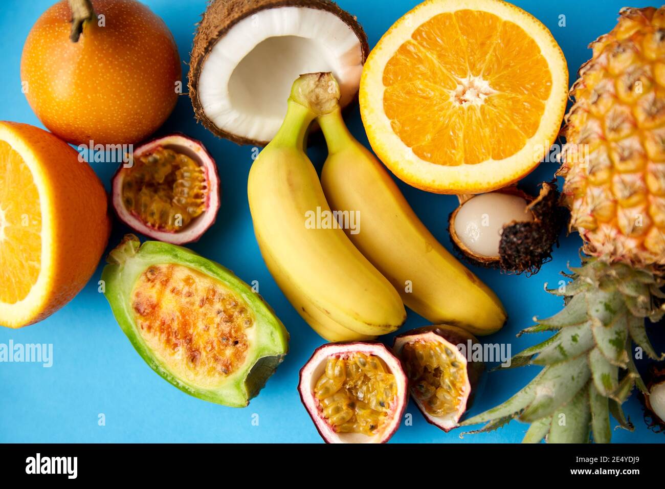 different exotic fruits on blue background Stock Photo - Alamy