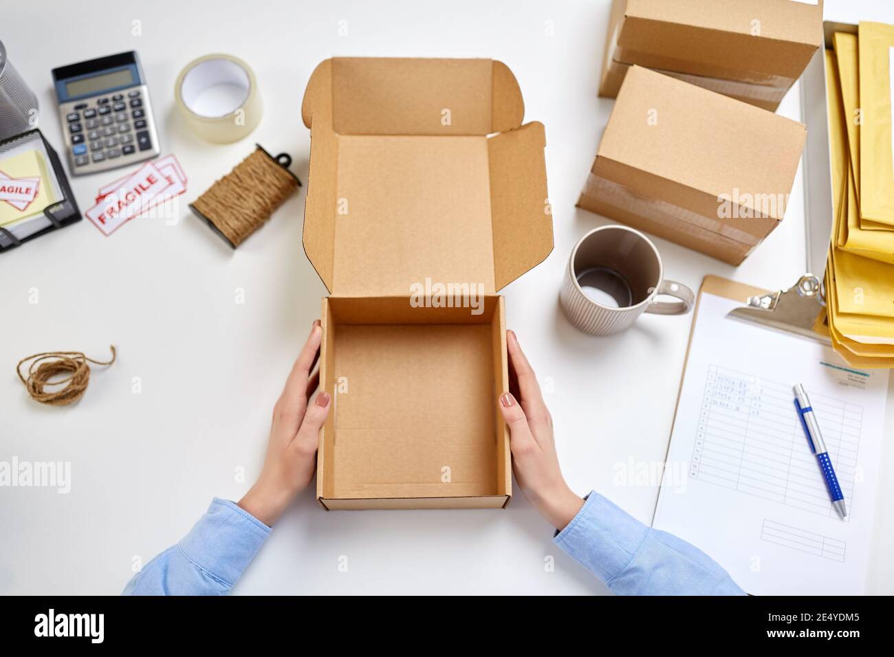hands with empty parcel box and mug at post office Stock Photo - Alamy