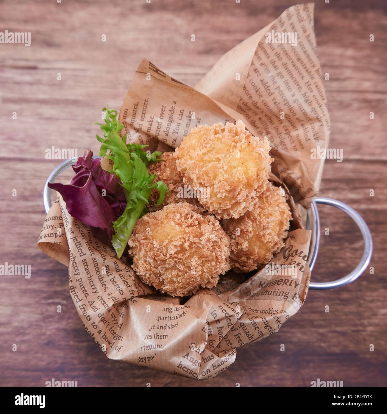 Top view of homemade ham croquettes in a bucket on rustic wooden ...