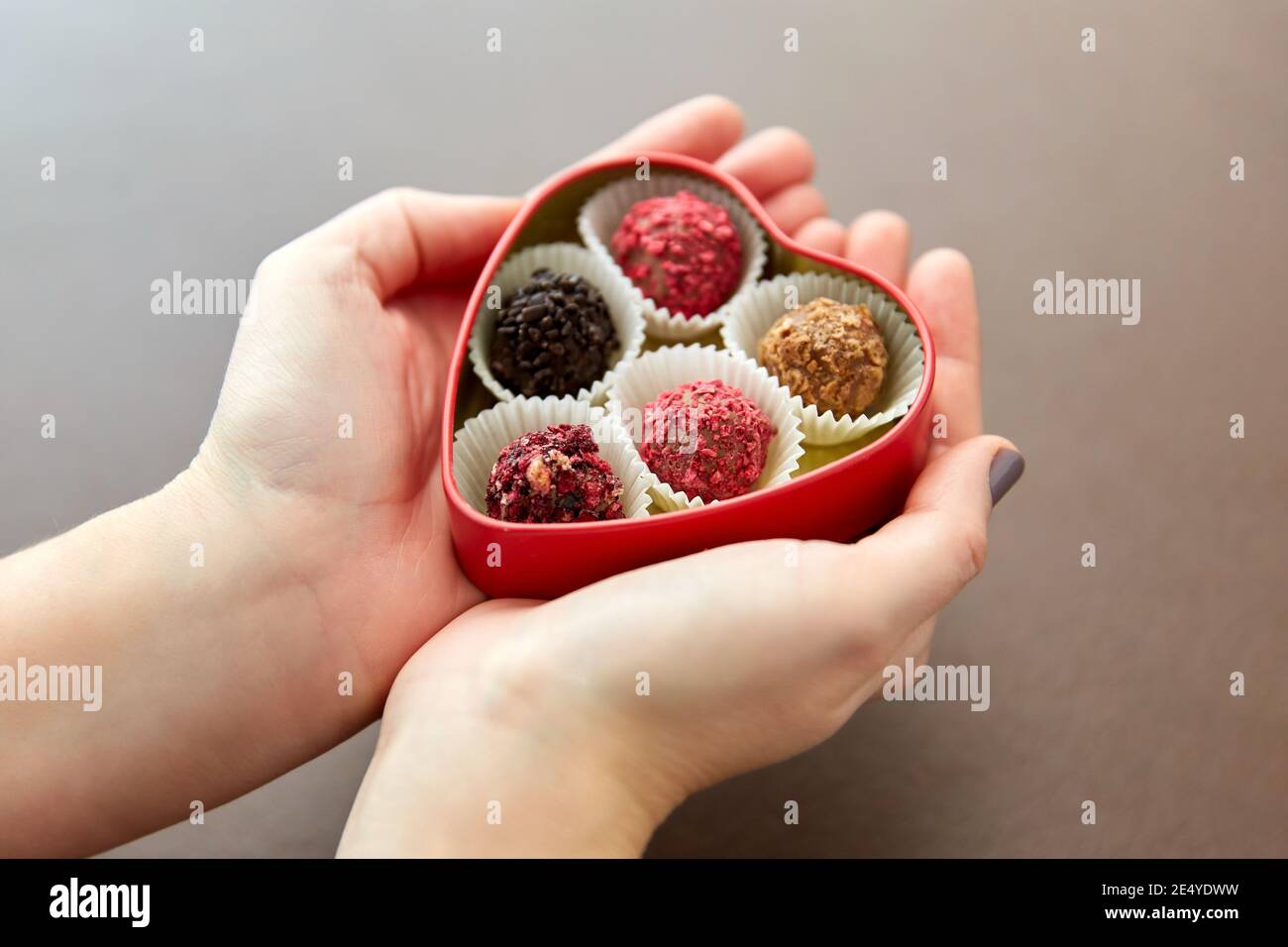 Hand holding chocolate box hi-res stock photography and images - Alamy