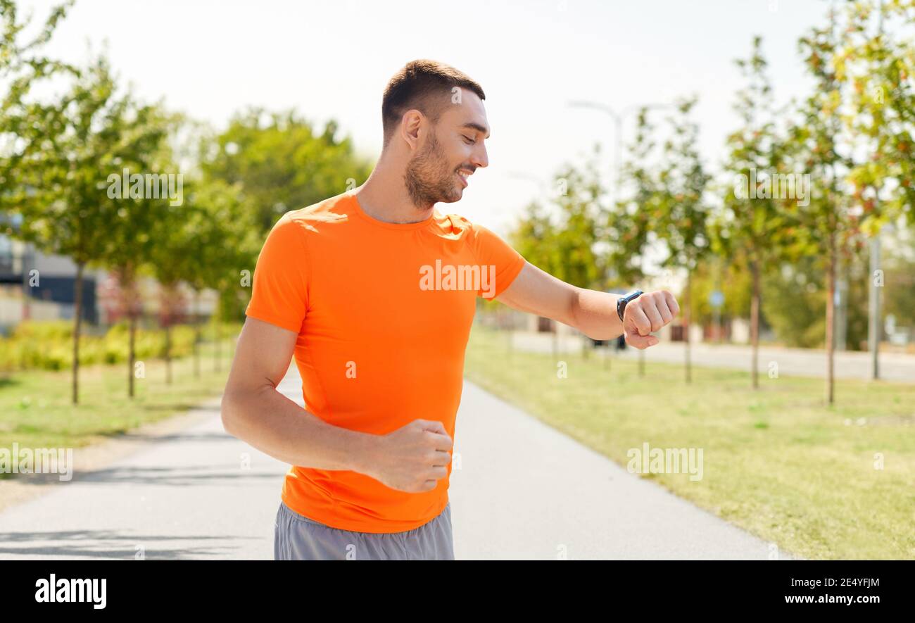 Man running with sports watch city hi-res stock photography and images ...