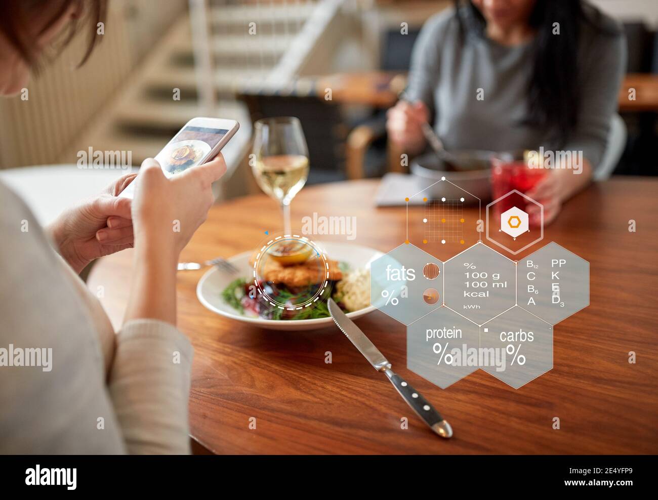 hands with phone and food nutritional value chart Stock Photo - Alamy