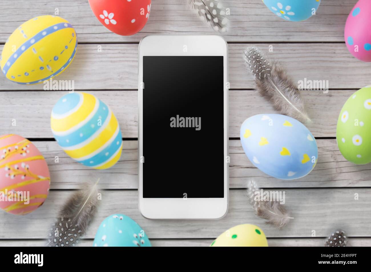 smartphone with easter eggs and feathers Stock Photo - Alamy