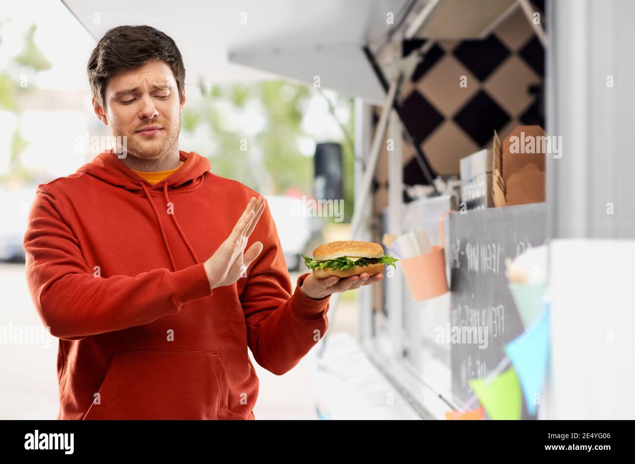 young man refusing from hamburger at food truck Stock Photo - Alamy