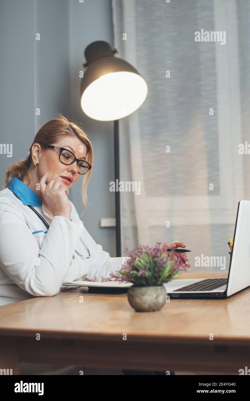 Senior doctor working from home is having online meeting with the ...