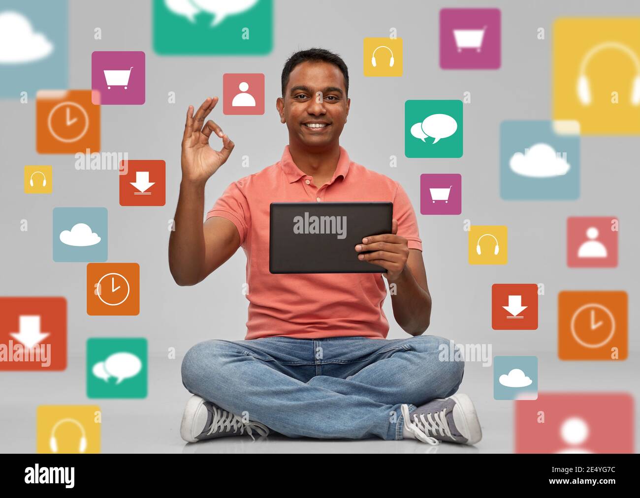 happy indian man with tablet pc over app icons Stock Photo - Alamy