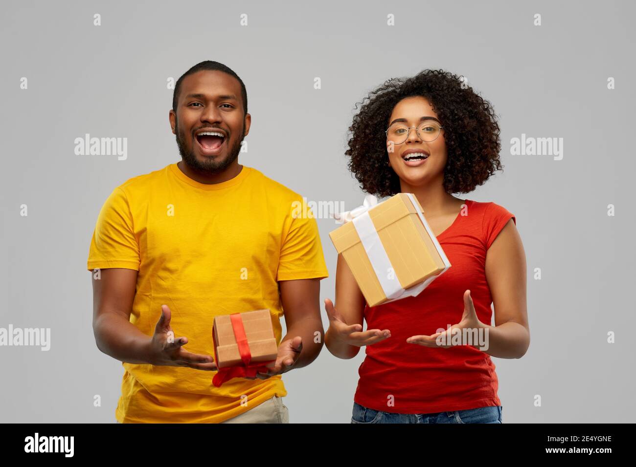 happy african american couple throwing gift boxes Stock Photo - Alamy