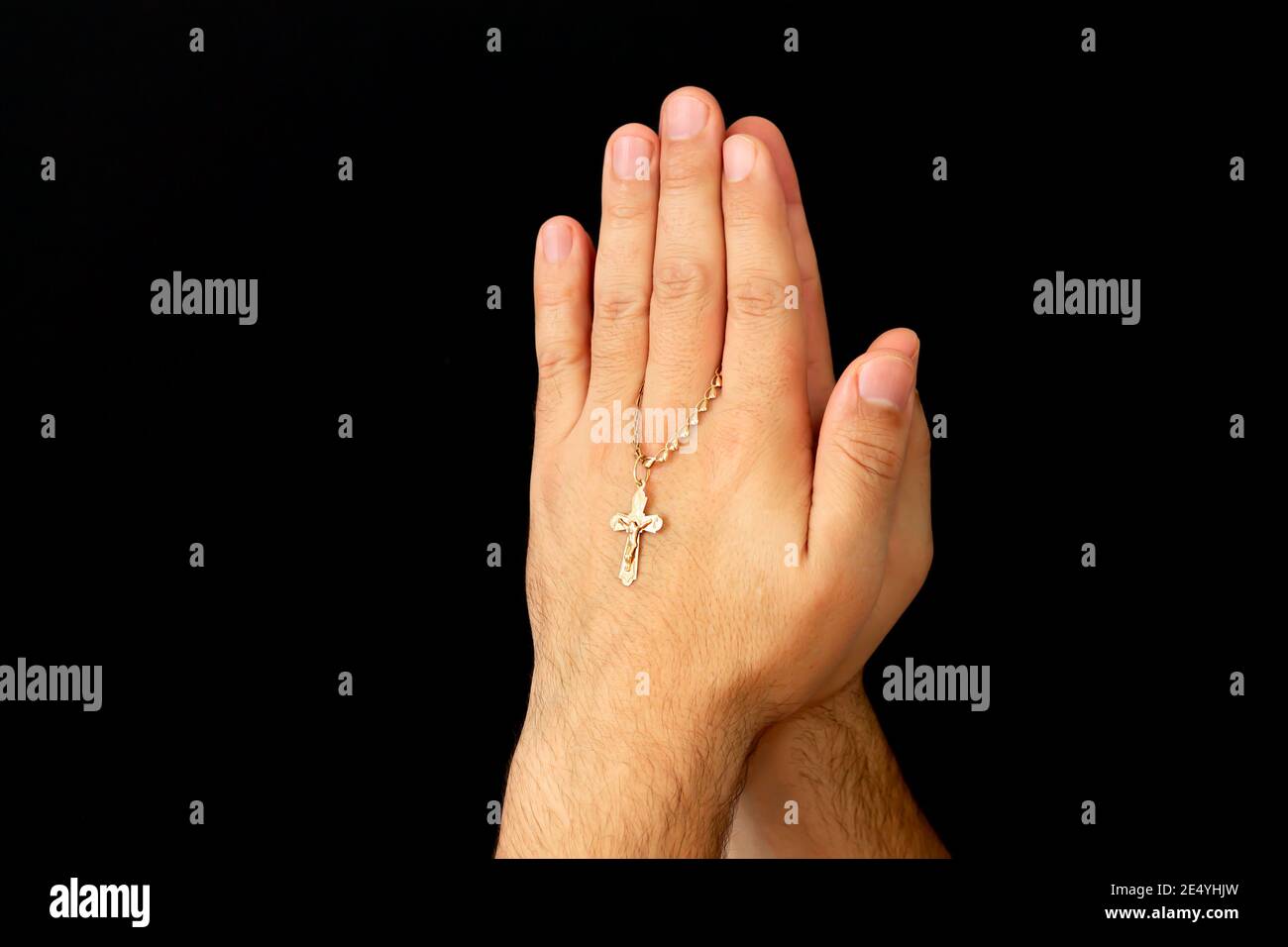 Bible praying hands holding cross hi-res stock photography and images ...